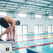 Sports, swimming and man on podium by pool for training, exercise and ...
