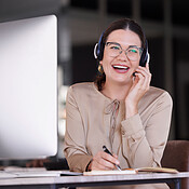 Call center, woman and writing notes for customer service ...