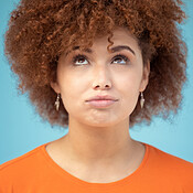 Comic, thinking and face of woman on blue background with ideas, vision ...