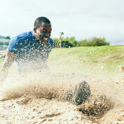 Long jump, fitness and black man in the sand for sports, exercise and ...
