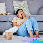 Cleaner woman tired from house work, yawning and relax on floor with ...