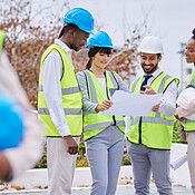 Architecture, collaboration and blueprint with a designer team working ...