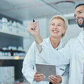 Science, collaboration and woman with man brainstorming, writing on ...