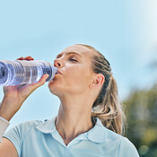 Woman, tennis player and drinking water for hydration after workout ...