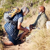 First aid, injury and knee pain with old men in nature for trekking ...