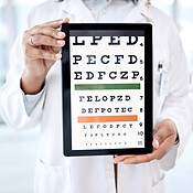 Hands, tablet screen and optometry chart in hospital for vision ...