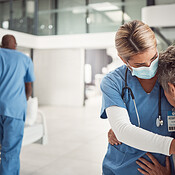 Doctor, hug and sad elderly woman in hospital for support, comfort and ...