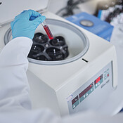 Hands, test tube or laboratory centrifuge in science research, person ...