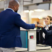 Businessman, airport and passenger assistant helping traveler with ...