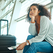 Airport, travel delay and sad woman with anxiety for immigration ...