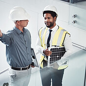 Engineer, electrician or team talking and planning construction project ...