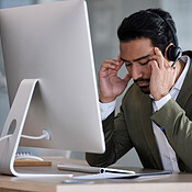 Telemarketing, headache and man with stress, call center and burnout in ...
