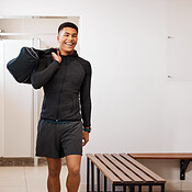 Sports, fitness and man in gym locker room with smile ready for game ...