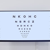 Eye chart, television and screen in hospital for optometry examination ...