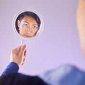 Makeup, reflection and gay man with mirror in hand with pride on purple ...