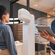 Eye exam machine, black woman and optometrist with tablet for vision ...