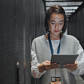 Tablet, server room and cloud computing with a programmer asian woman ...