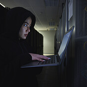 Hacker, server room and woman computer coding, data center crime and ransomware of cyberpunk in ...
