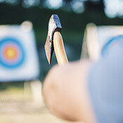 Man throwing axe at sports range, archery training or practice with ...