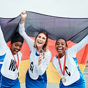 Netball winner portrait, flag or sports team celebration, excited or ...