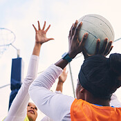 Netball, goal shooter and fitness of a girl athlete group on an outdoor ...
