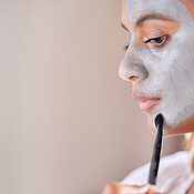 Woman brush clay makeup on face, mask and detox beauty benefits with ...