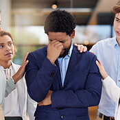 Black man, stress or headache with team for support on mental health ...