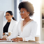 Serious black woman, computer and working in focus checking corporate ...