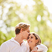 Hug, love and couple kiss for happy, quality time and bonding on ...