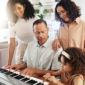 Family, keyboard piano and playing music with grandparents, mother and ...