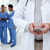 Healthcare, hospital and hands of doctor with phone for research ...