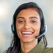 Happy, friendly and confident face of a call center agent smiling in ...