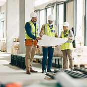 Building, construction and architect with a team working on site while ...