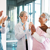Doctor, nurse and team applause in celebration for healthcare achievement, goal or promotion at ...