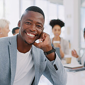 Meeting, office and face of a professional black man sitting at a table ...