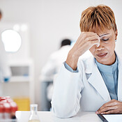 Scientist with headache, stress and fatigue with woman, overworked with ...