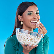 Black woman, studio portrait and eating popcorn, smile or makeup for ...
