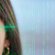 Woman, eye and biometrics on overlay in matrix for cybersecurity ...