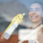 Window cleaning, woman smile and happy maid at home washing windows ...