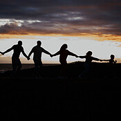 Sunset, beach and silhouette of family with children by ocean for ...