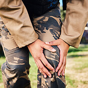 Hands, soldier and knee injury in paintball sport, running or military ...