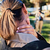 Closeup, neck pain and hand of woman with injury in paintball, sports ...