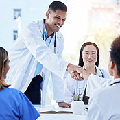 Handshake, doctors and medical meeting in agreement, collaboration and smile of teamwork ...
