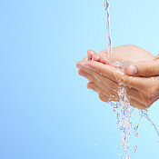 Water splash, woman or cleaning hands in studio on blue background for ...