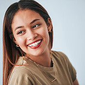 Woman, smile and happiness of a gen z female in a studio with gray ...