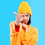 Portrait, hand gesture and rude with a woman on a blue background in ...