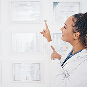 Graduation, pointing and healthcare award with a woman proud of her ...
