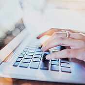 Hands, laptop and keyboard with person typing or writing article on ...