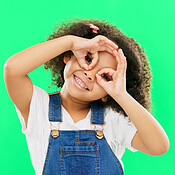Green screen, happy and child with hands by eyes for glasses gesture ...