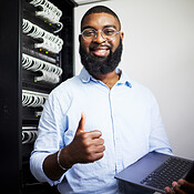Server room, laptop and thumbs up with technician man for internet ...